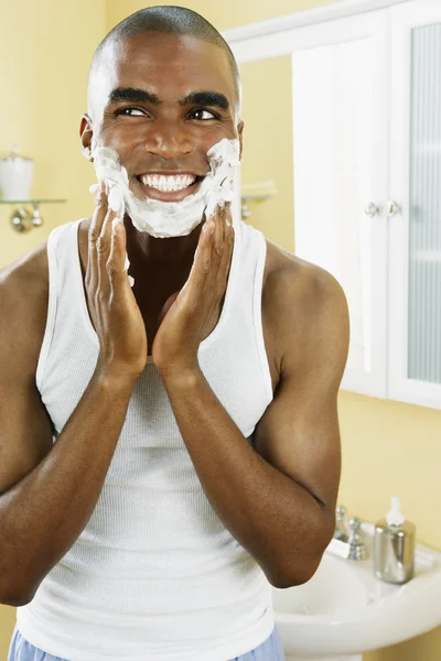 African man applying shaving cream - Stock Image - Everypixel