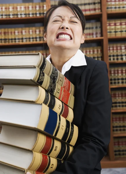 Woman carrying stack of library reference books - Stock Image - Everypixel