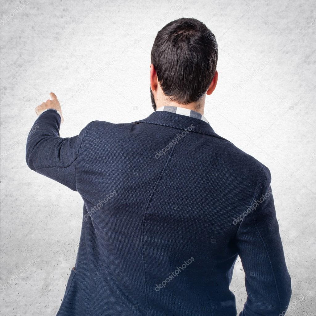Handsome man pointing back — Stock Photo © luismolinero #105156082 Handsome man pointing back — Stock Photo © luismolinero #105156082
