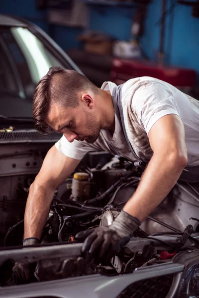 Car mechanic fixing broken motor - Stock Image - Everypixel