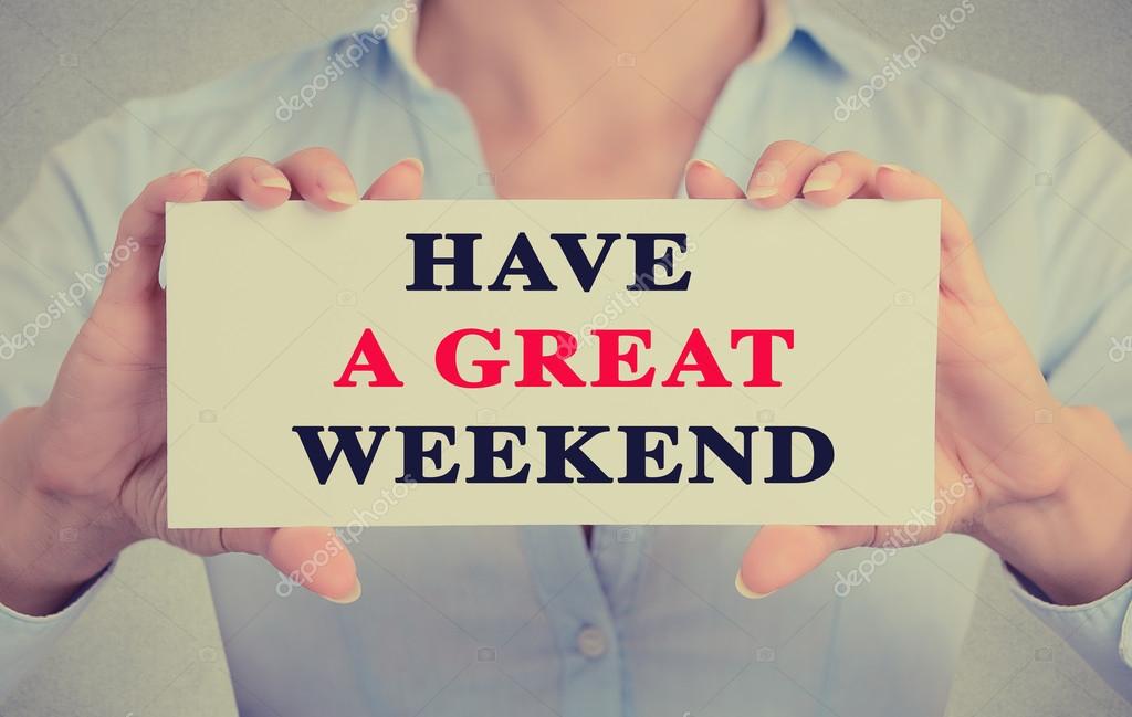 Businesswoman hands holding sign with have a great weekend text message ... Businesswoman hands holding sign with have a great weekend text message ...