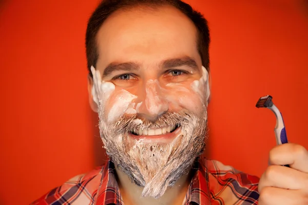 Handsome man with shaving foam on his face and razor - Stock Image - Everypixel