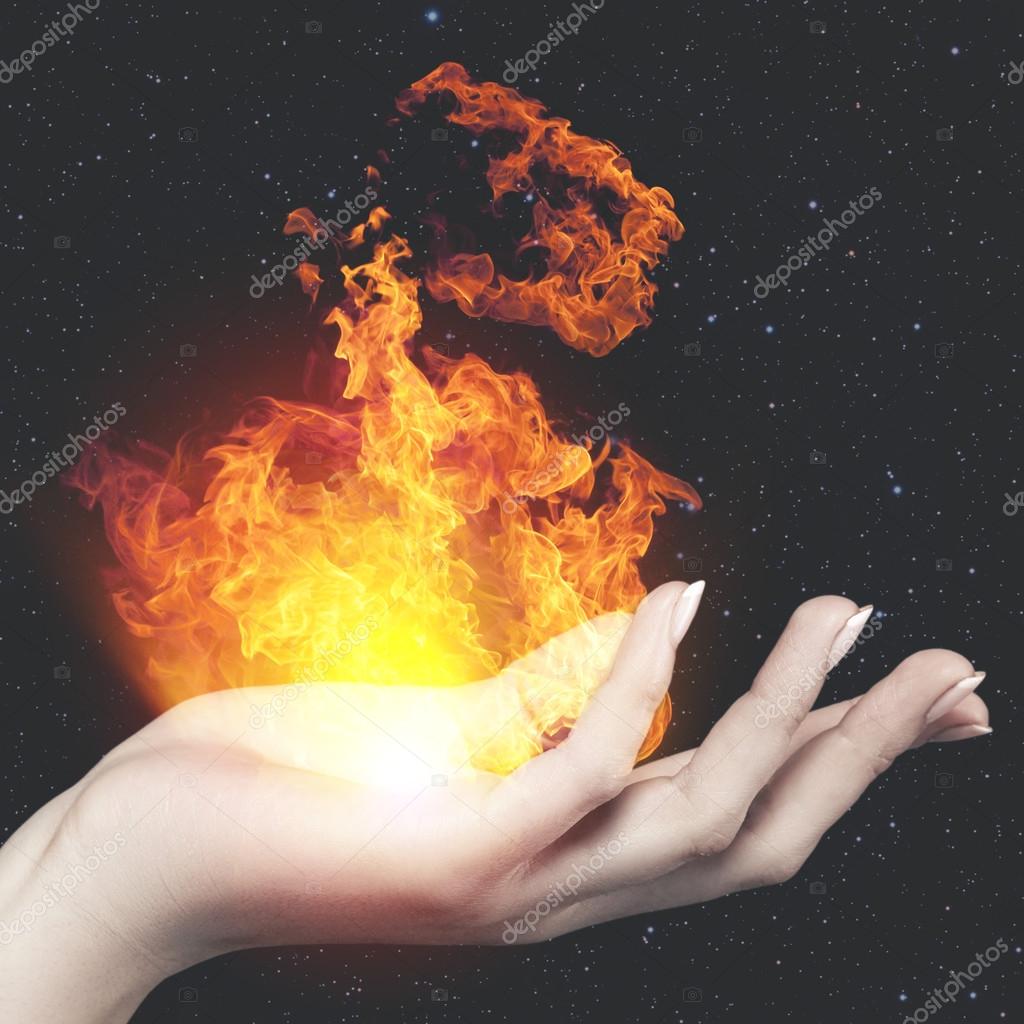 Burning fire in female hand Stock Photo by ©tolokonov 113384502
