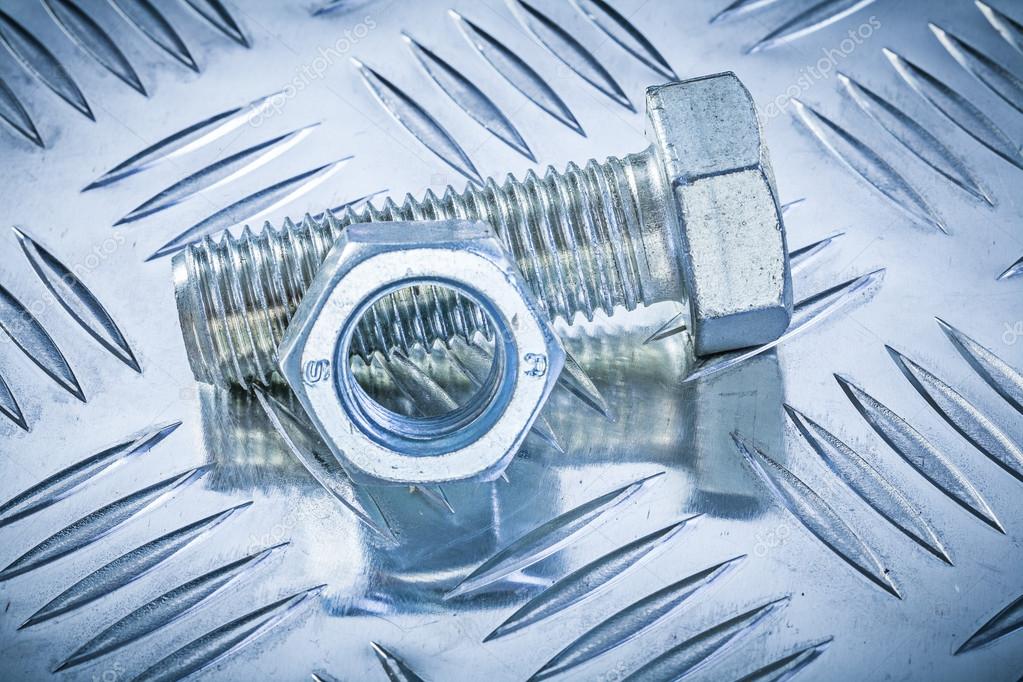 Stainless bolt detail threaded screw-nut on corrugated metal she ...