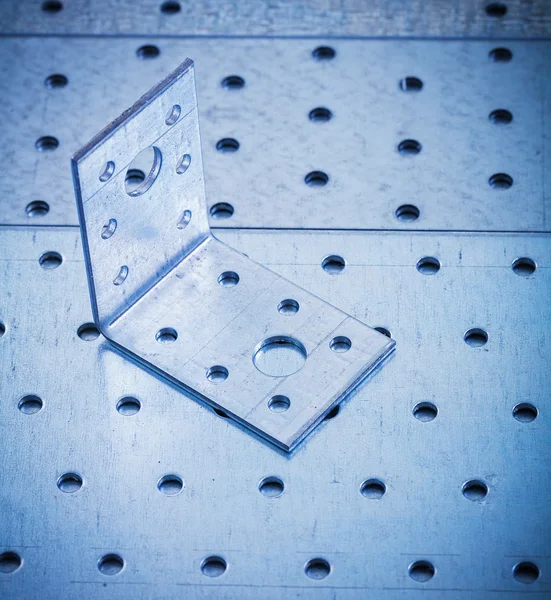 Stainless drilled angle bars Stock Photo by ©mihalec 74906397