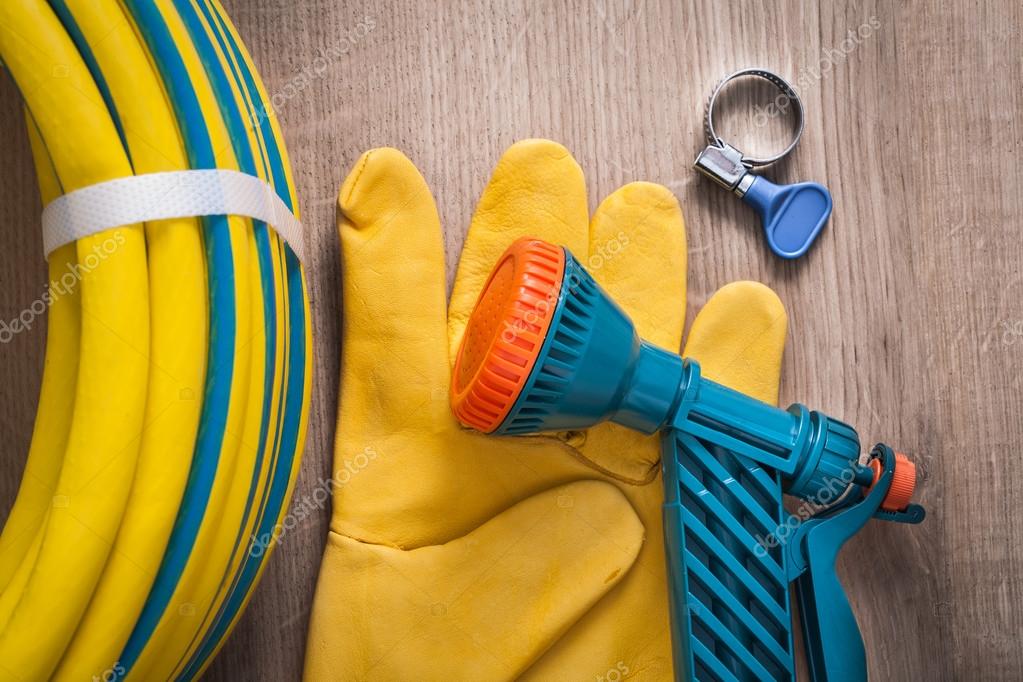 Rubber hose with safety gloves Stock Photo by ©mihalec 78565530