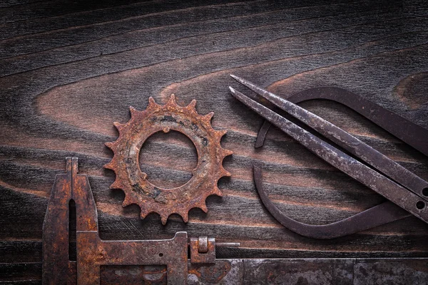 Rusty measuring calipers with cog- wheel Stock Photo by ©mihalec 80369100