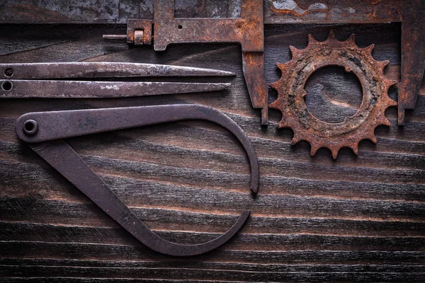 Rusty measuring calipers with cog- wheel Stock Photo by ©mihalec 80369100