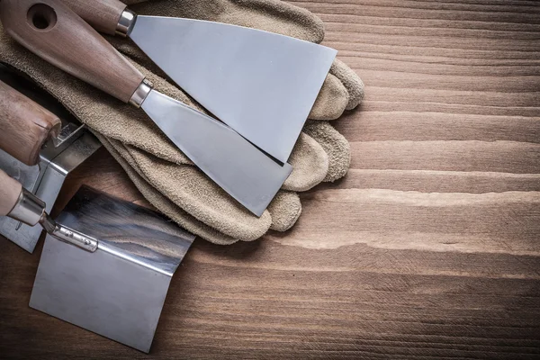 Paint scrapers on gloves and angle surfacers - Stock Image - Everypixel