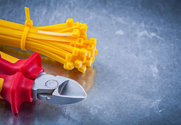 Nippers and plastic zip cable ties Stock Photo by ©mihalec 97868314