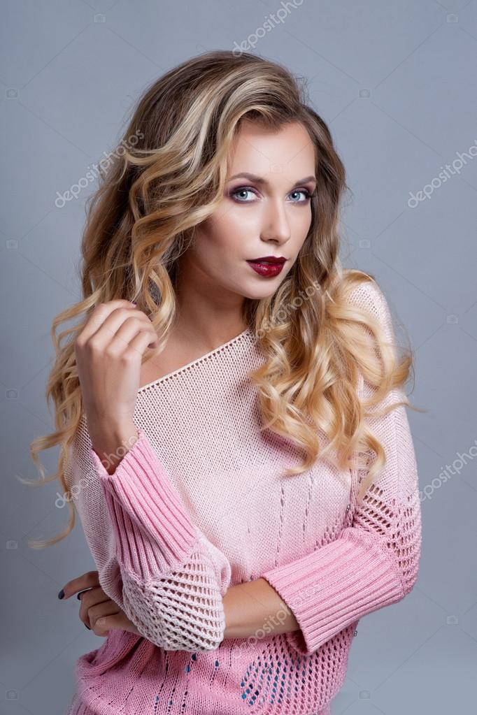Portrait of beautiful blonde woman with curly hairstyle and bright ...