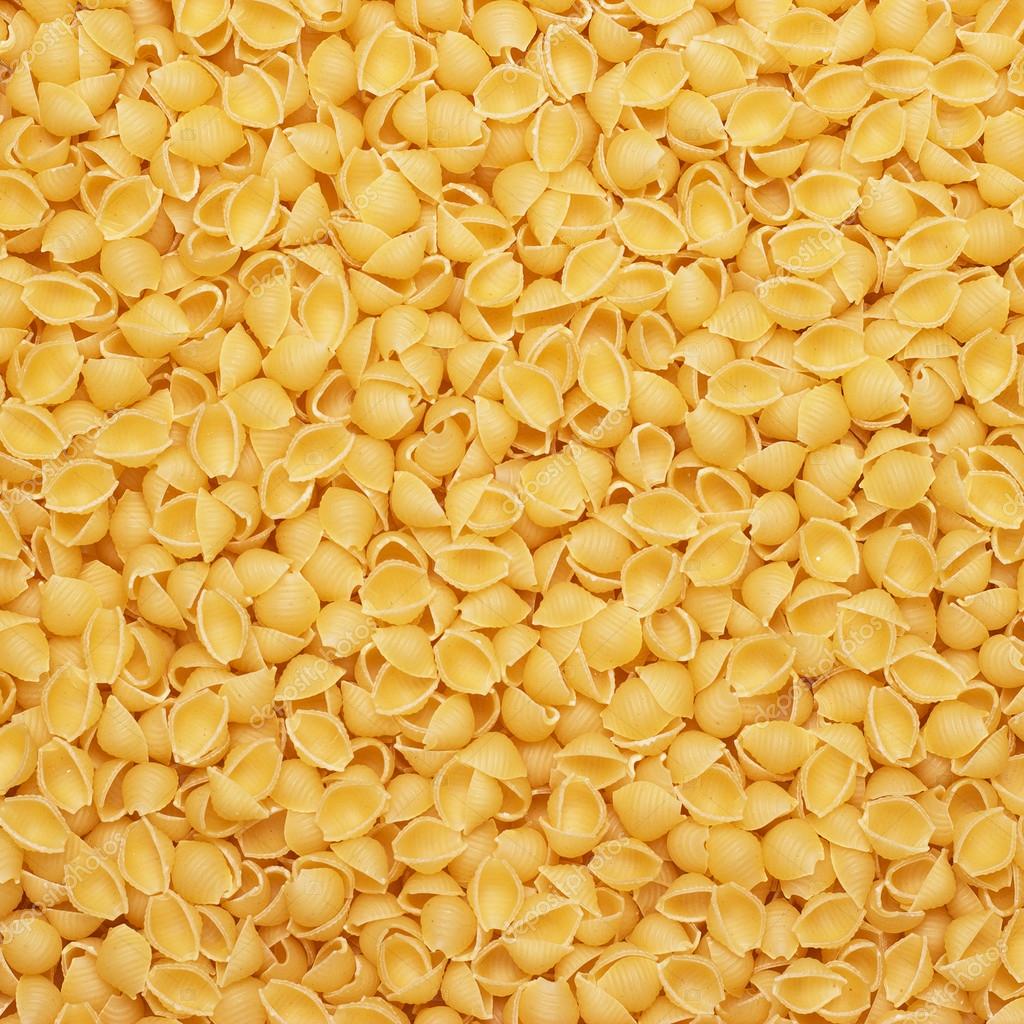 Dry uncooked macaroni texture background — Stock Photo © garloon #64882009