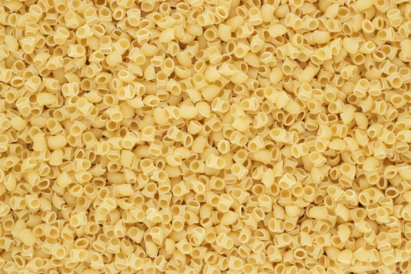Dry uncooked pasta texture background Stock Photo by ©garloon 85776268