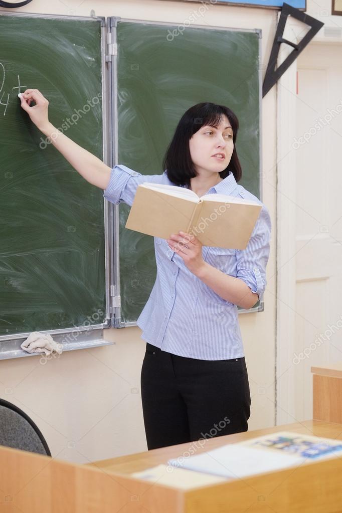 Teacher stands at blackboard — Stock Photo © uatp12 #73708967
