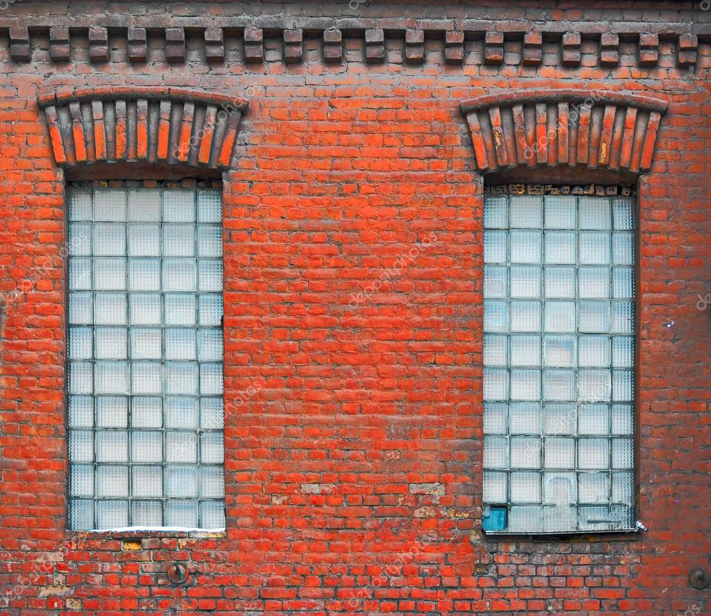 Two old windows with square glass blocks in old worn down factory ...