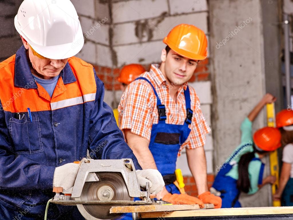 Group people builder with circular saw — Stock Photo © poznyakov #63454535