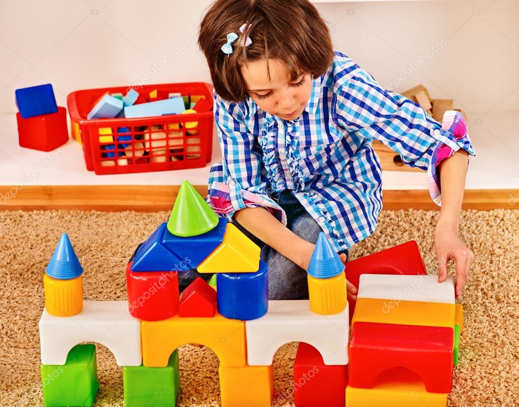 Child playing bricks. — Stock Photo © poznyakov #70762737