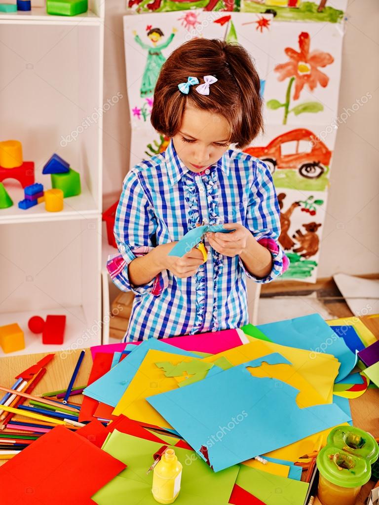 Child with scissor at school. Stock Photo by ©poznyakov 72698689