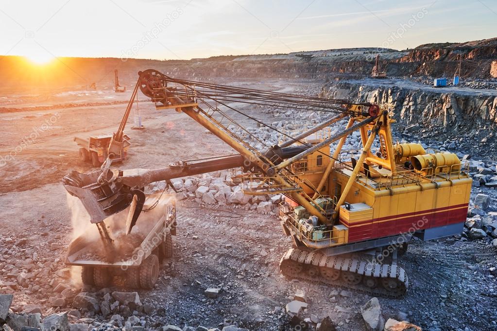Mining. excavator loading granite or ore into dump truck — Stock Photo ...