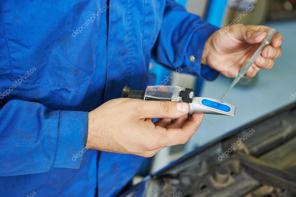 Auto mechanic tests car antifreeze liquid Stock Photo by ©kalinovsky ...