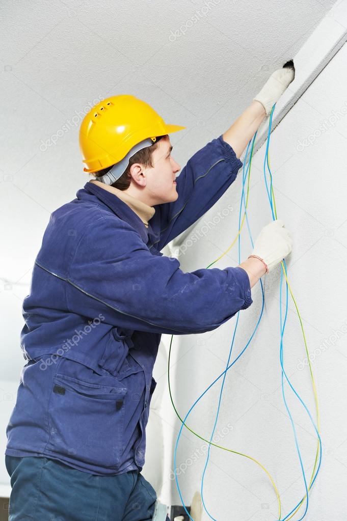 Electrician at cable wiring work — Stock Photo © kalinovsky #75473075