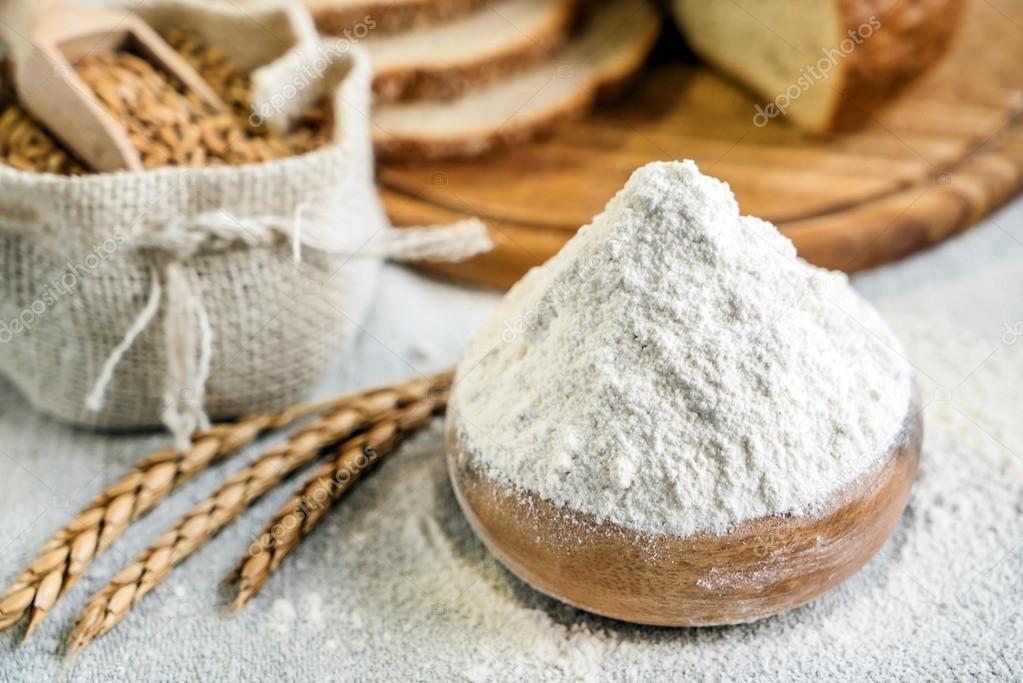 Wheat and flour on table Stock Photo by ©Shebeko 117876548