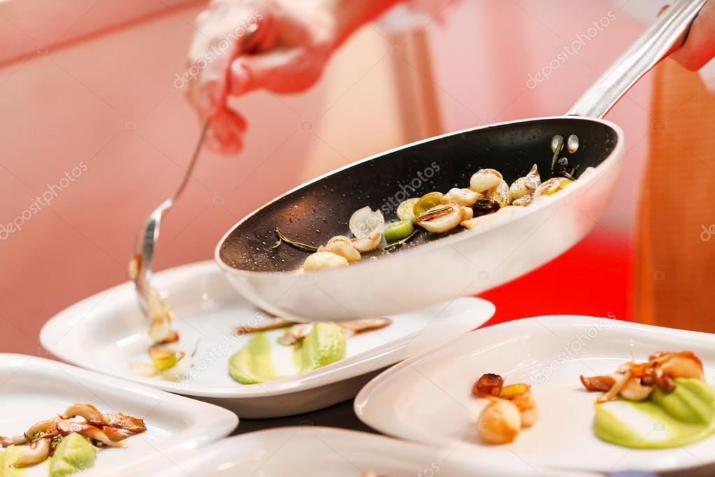 Chef putting food on plates Stock Photo by ©Shebeko 73079167