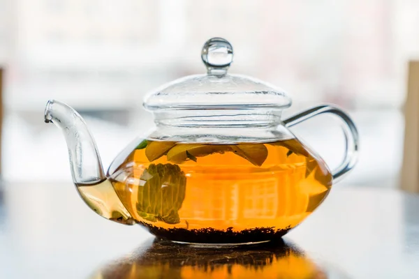 Teapot of fresh tea on wooden table Stock Photo by ©efired 31386643
