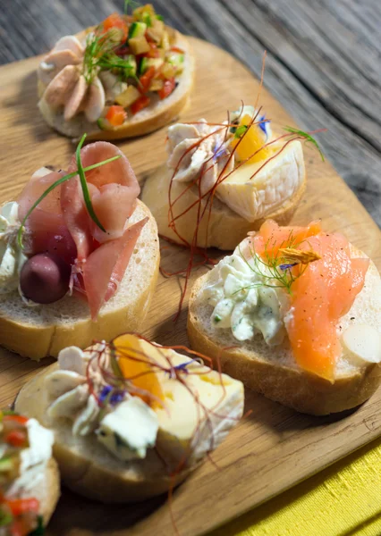 Variety delicious canapes Stock Photo by ©fotovincek 98133424