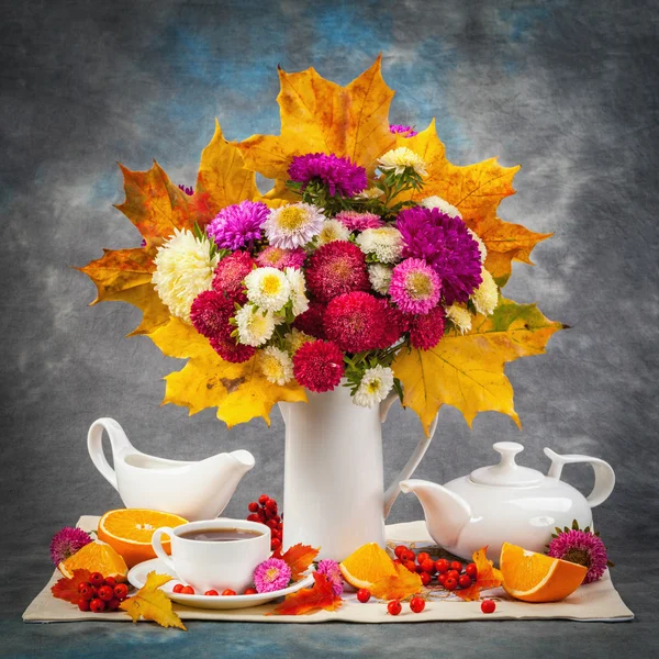 Autumn still life. Tea, flower and yellow leaves — Stock Photo ...