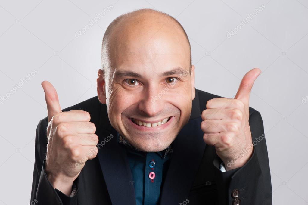 Man making a silly face and giving thumb up — Stock Photo © spaxiax ...