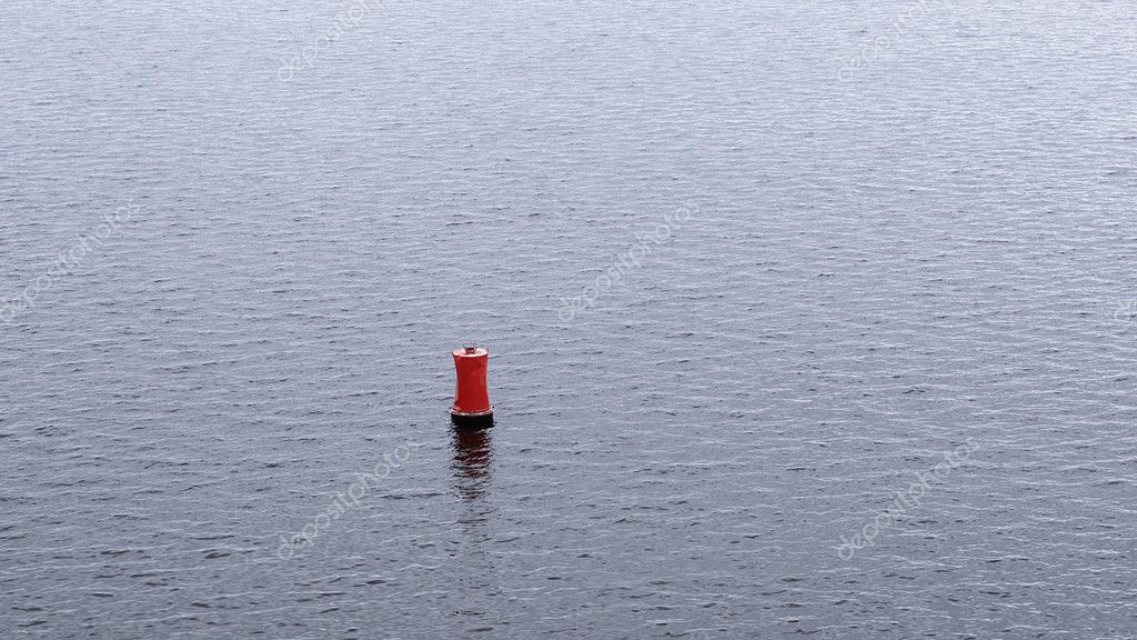 Red buoy floating on rippled water Stock Photo by ©MrHamster 113545600