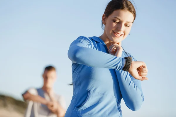 Runner woman with heart rate monitor running on beach — Stock Photo ...