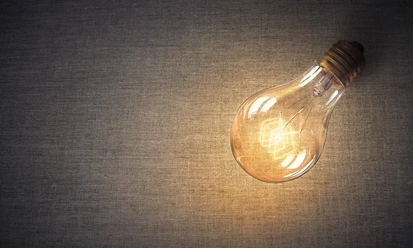 Light bulb on stone surface Stock Photo by ©SergeyNivens 112128106