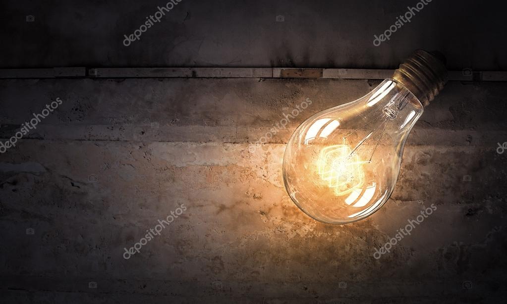 Light bulb on stone surface Stock Photo by ©SergeyNivens 111474120