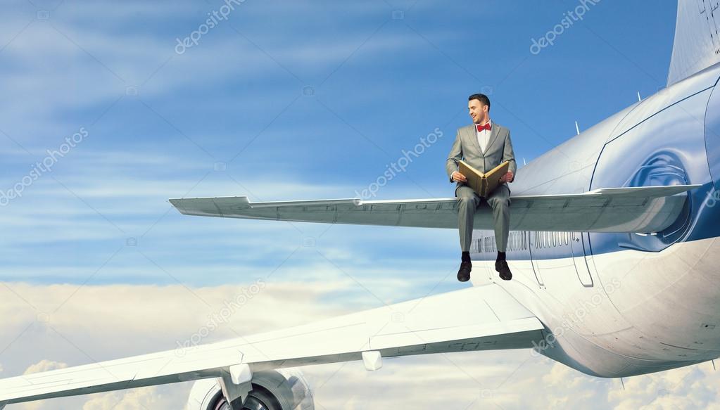 On wing of flying airplane . Mixed media — Stock Photo © SergeyNivens ...