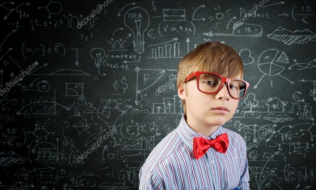 Genius boy near blackboard with formulas — Stock Photo © SergeyNivens ...