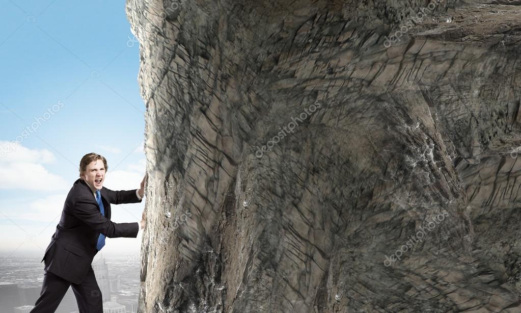 Businessman move brick wall Stock Photo by ©SergeyNivens 52672457