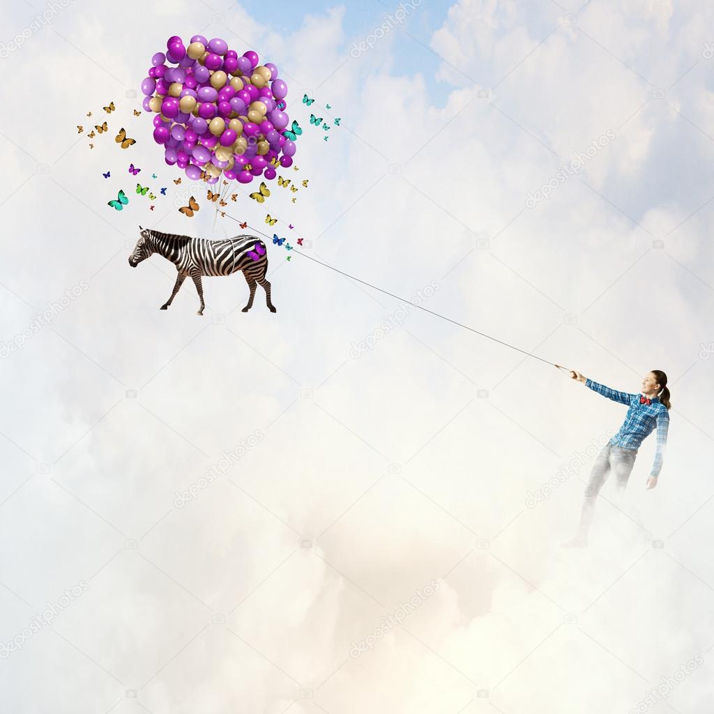 Woman and zebra flying in sky — Stock Photo © SergeyNivens #52720847