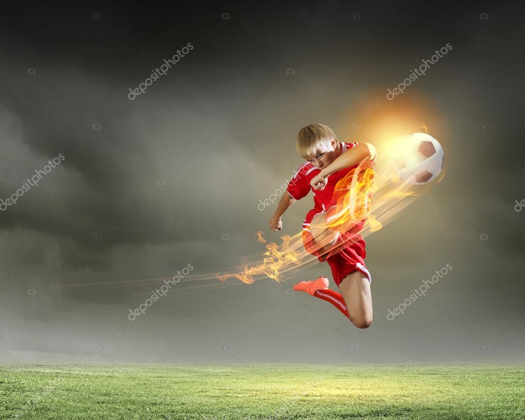 Football player kicking ball Stock Photo by ©SergeyNivens 53113801