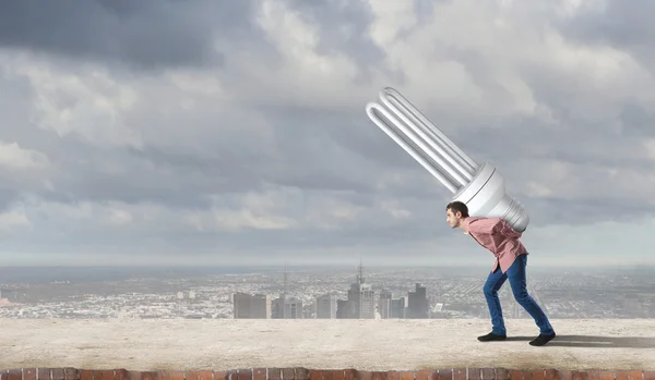 Man carrying a light bulb Stock Photos, Royalty Free Man carrying a ...