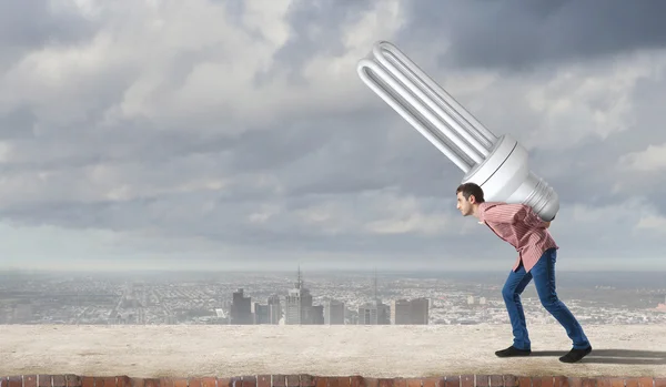 Man carrying a light bulb Stock Photos, Royalty Free Man carrying a ...