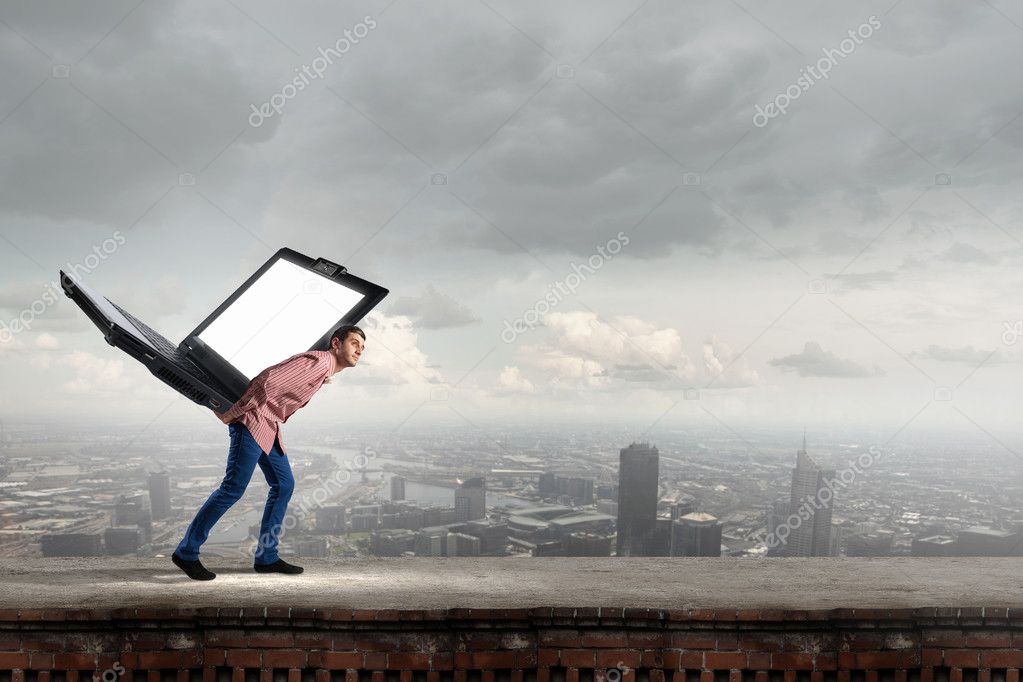 Guy carrying laptop Stock Photo by ©SergeyNivens 77687102