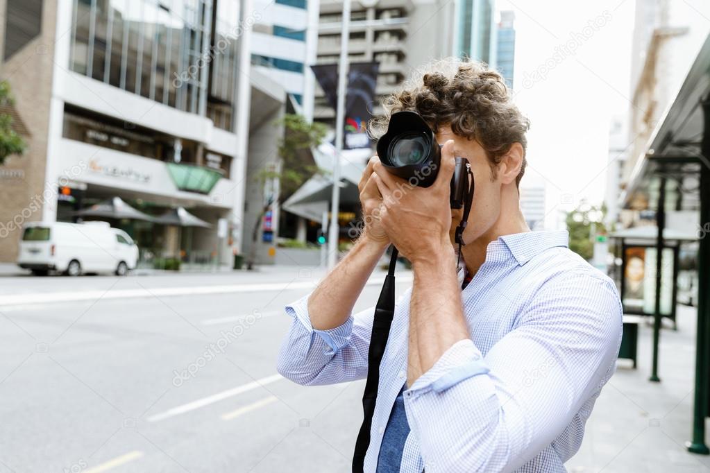 Male photographer taking picture Stock Photo by ©SergeyNivens 96291264