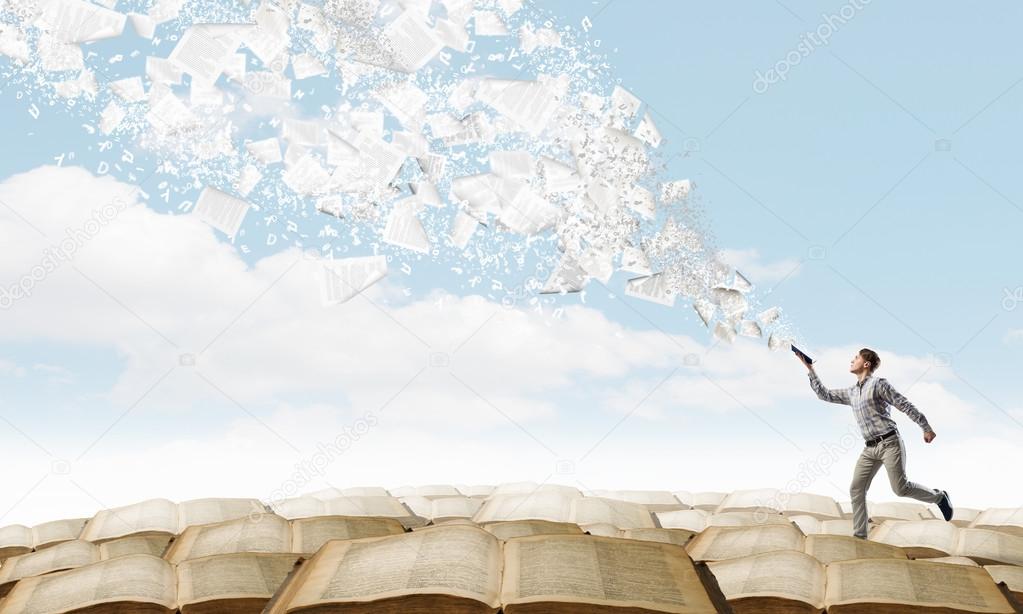 Man running with book Stock Photo by ©SergeyNivens 96404190