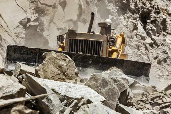 Bulldozer cleaning landslide from road in Himalayas Stock Photo by ...