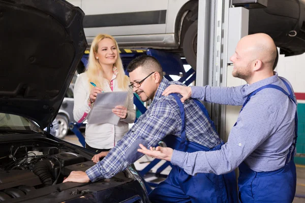 Manager and crew check up of car - Stock Image - Everypixel