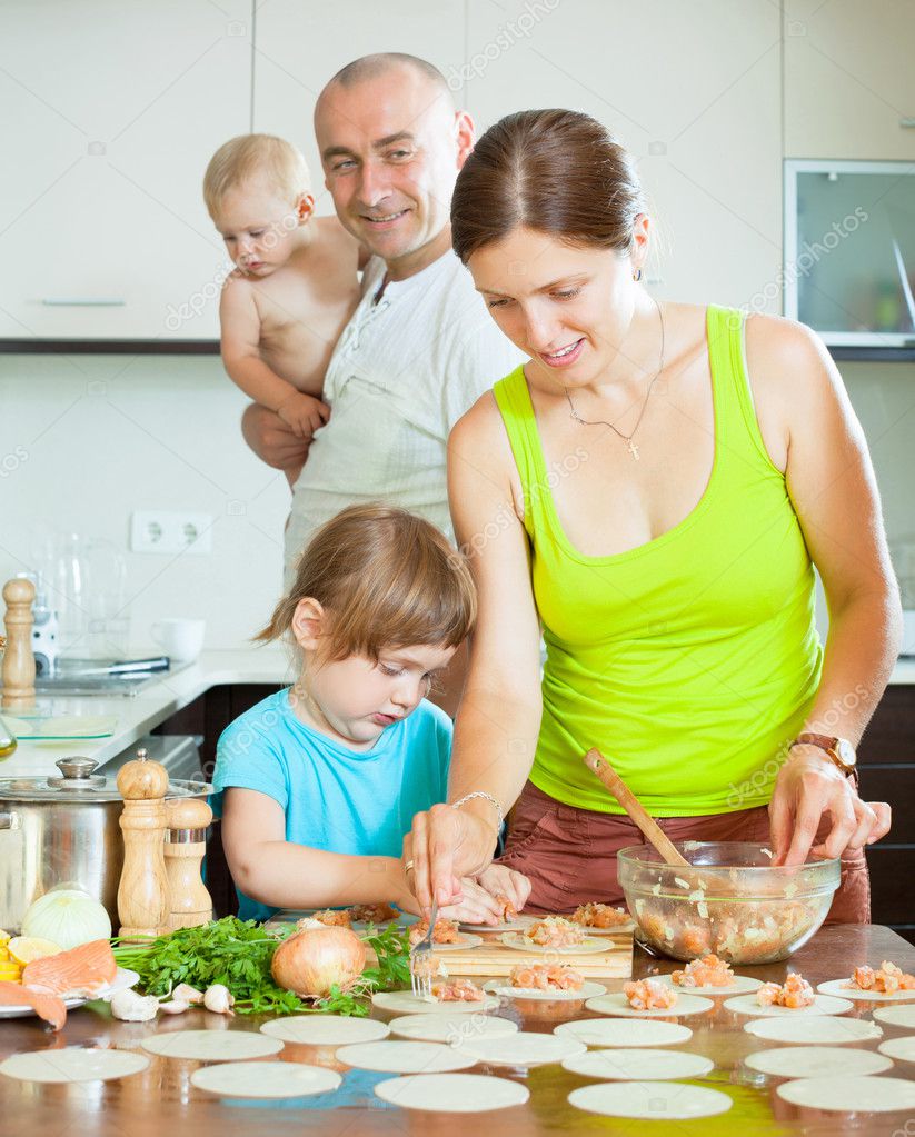 Family of four making dumplings Stock Photo by ©Jim_Filim 77485238 Family of four making dumplings Stock Photo by ©Jim_Filim 77485238