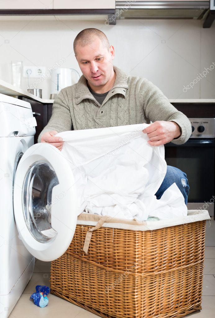 Man using washing machine — Stock Photo © Jim_Filim #77486558