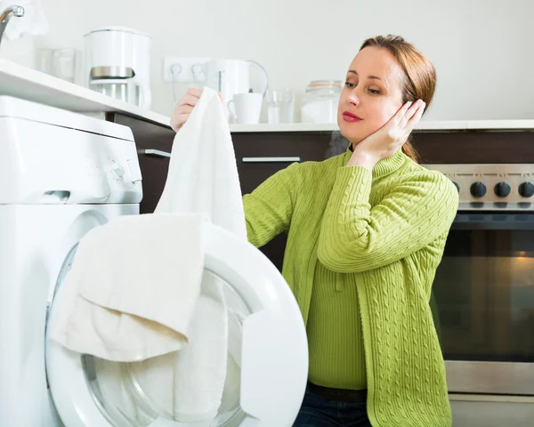 Sad woman near washing machine - Stock Image - Everypixel